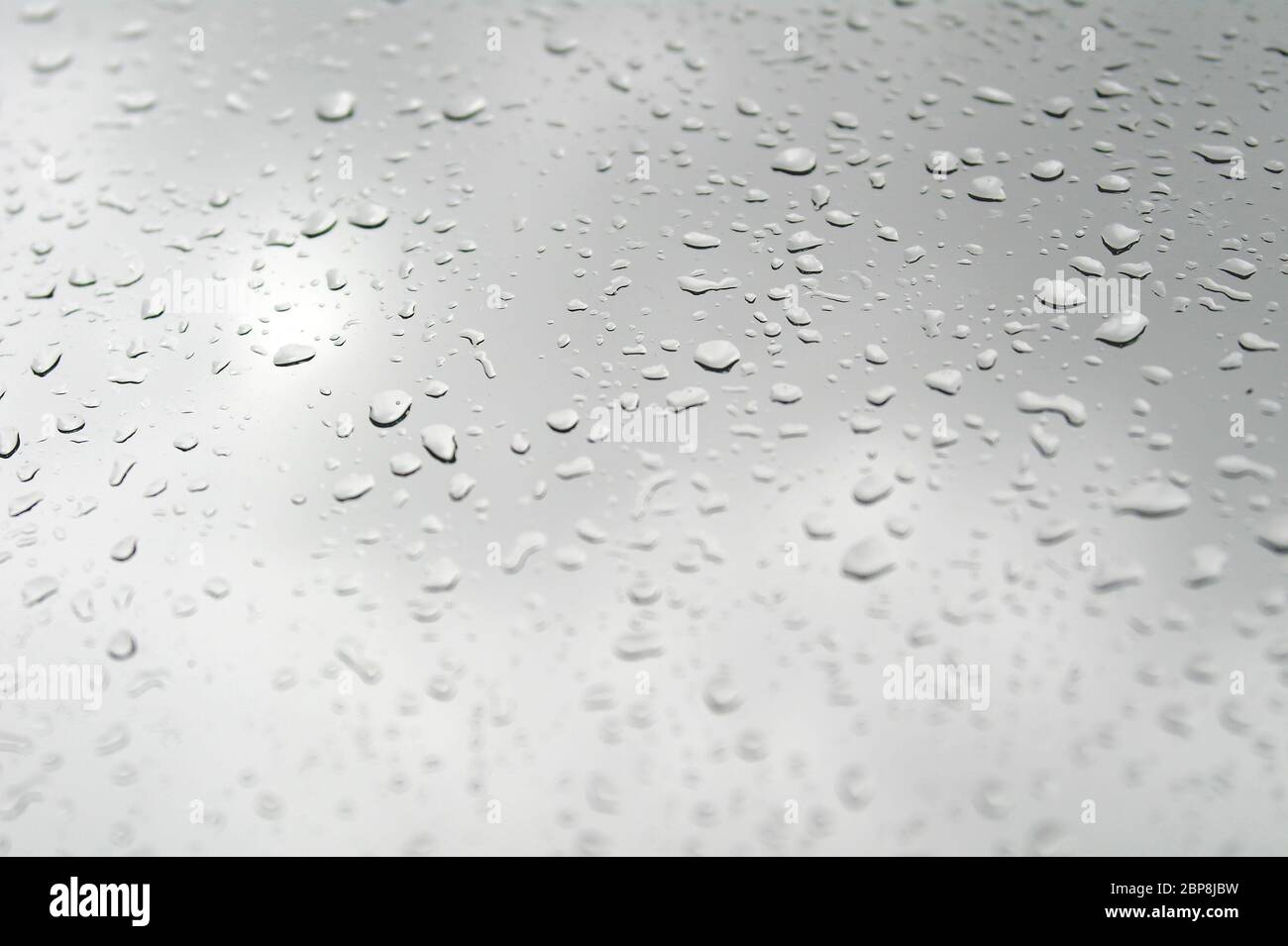 Drops of rain on the inclined window. Shallow DOF Stock Photo - Alamy