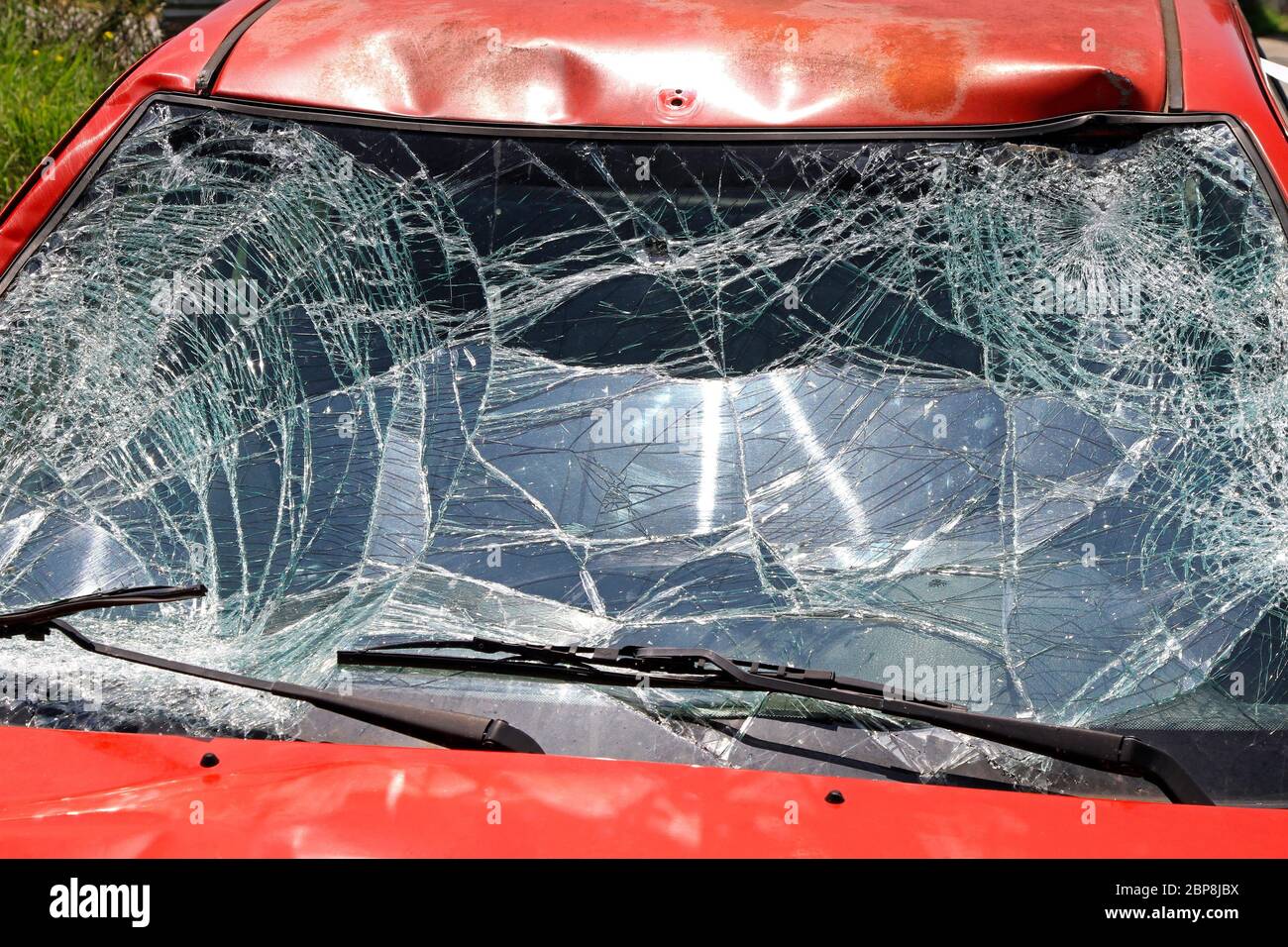 Broken Windshield at Red Car in Traffic Accident Stock Photo - Alamy