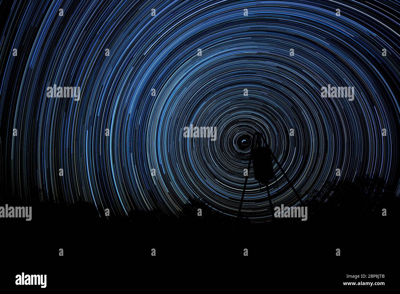 Long exposure of stars creating star trails (Stacked photos Stock Photo ...