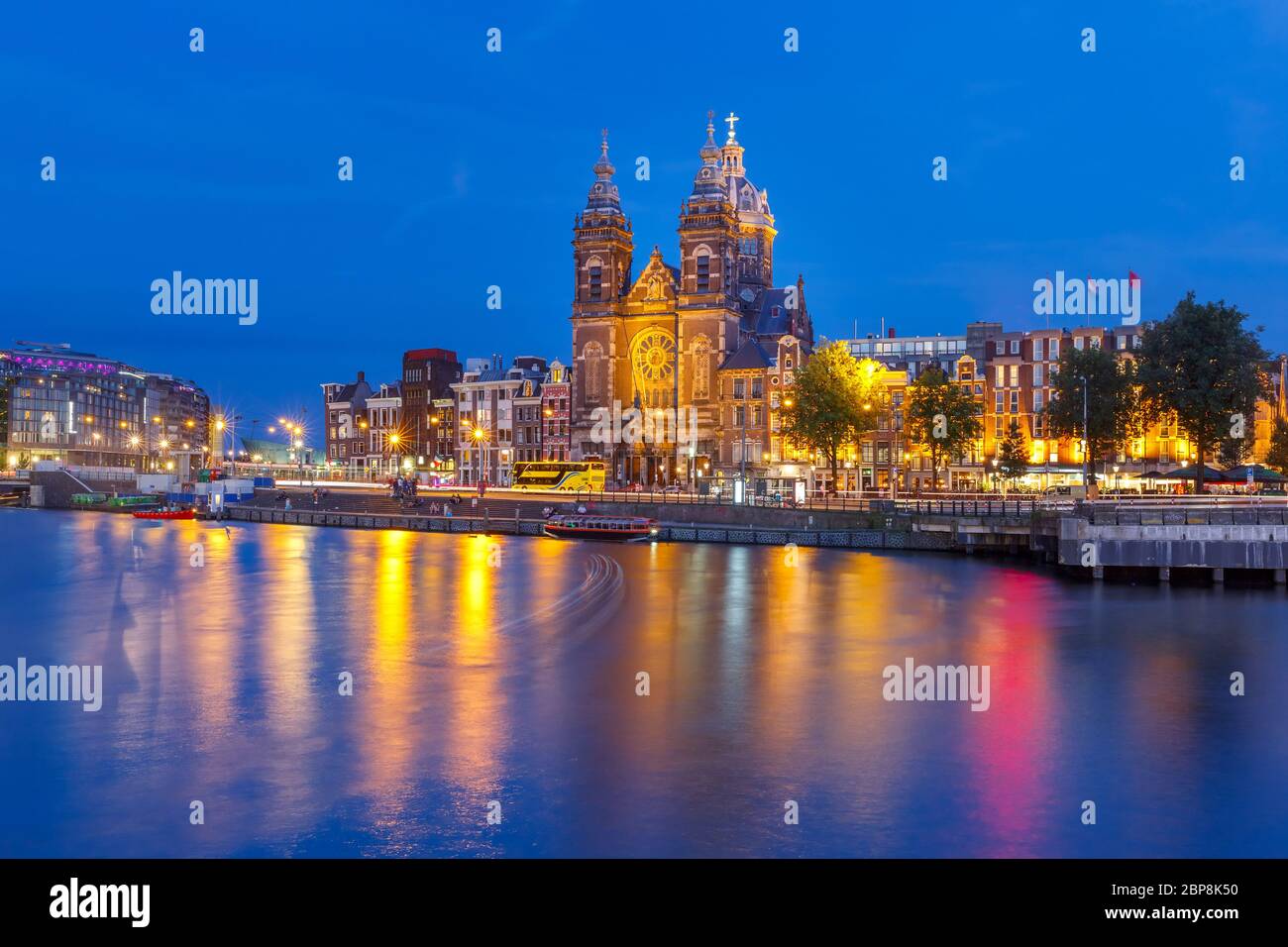 Night panoramic city view of Amsterdam canal, bridge and Basilica of ...
