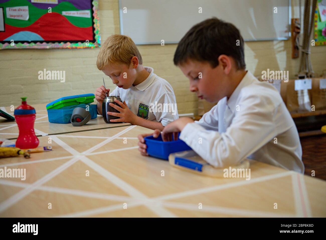 Children of essential workers eat lunch in segregated positions at ...