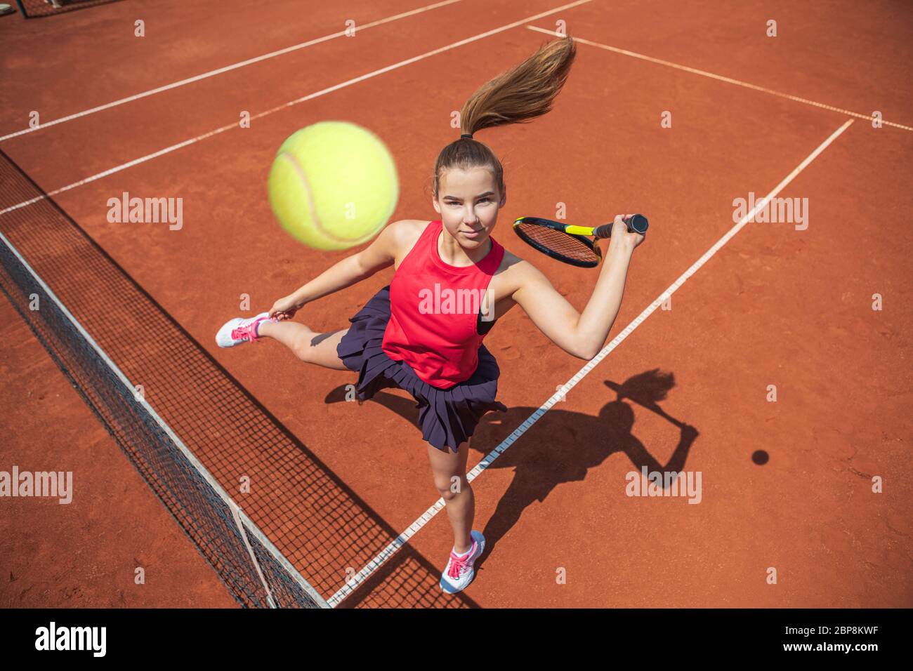 female tennis player with a racket on the court Stock Photo - Alamy