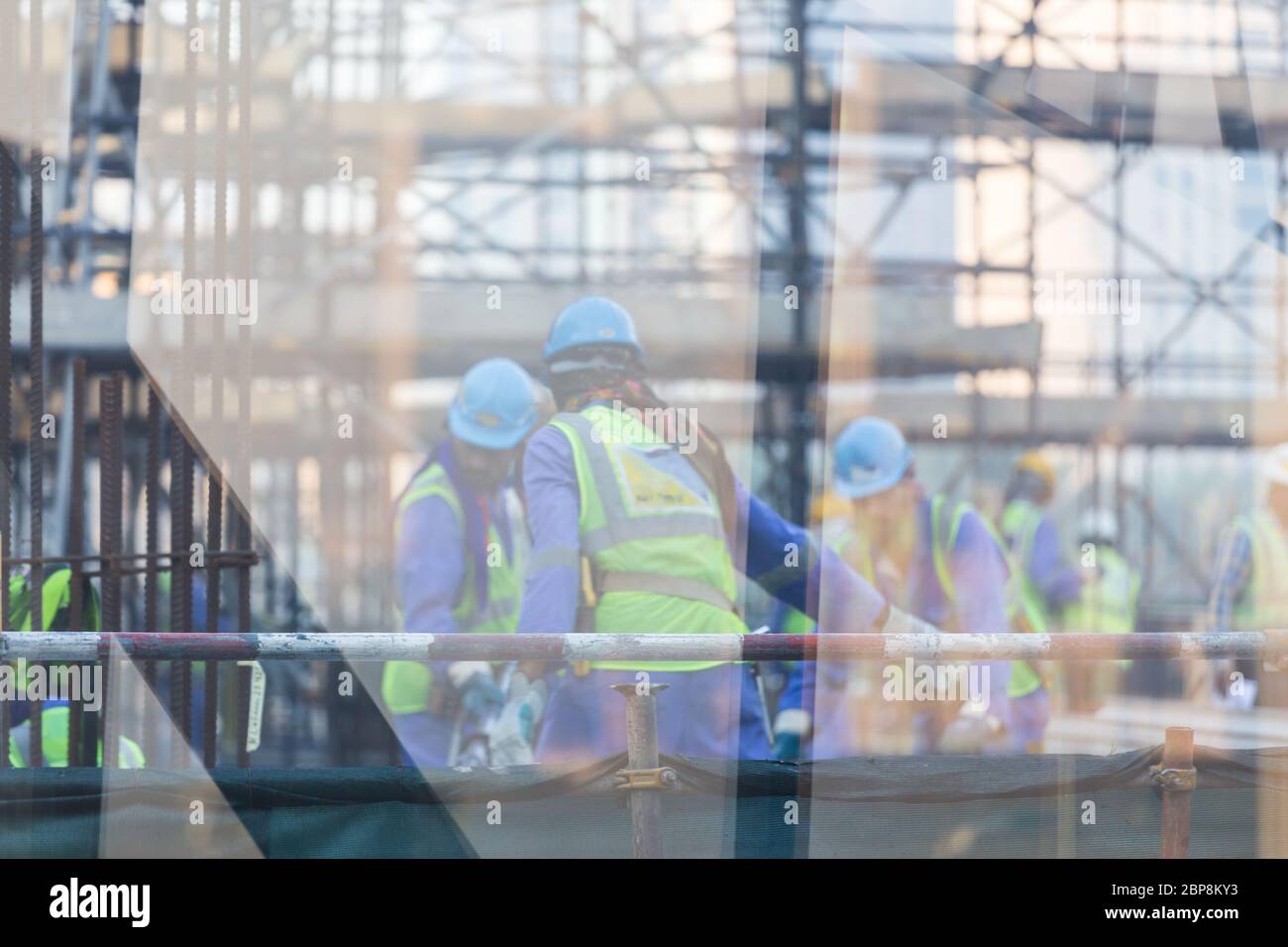 Construction site with team of construction laborers working on ...