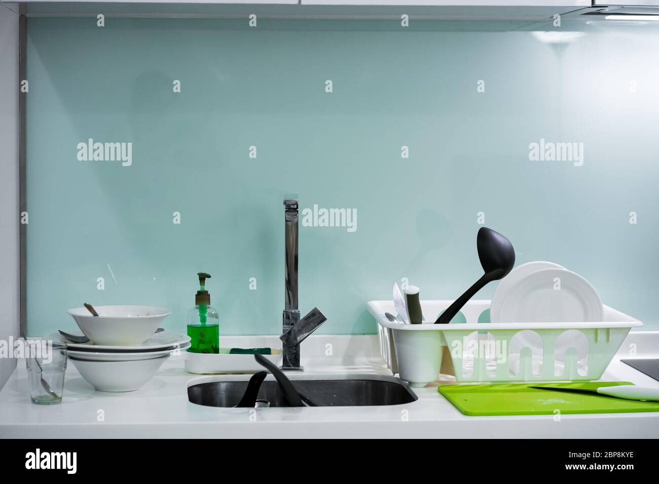 A mountain of dirty dishes in the kitchen sink. Mess in the house Stock ...