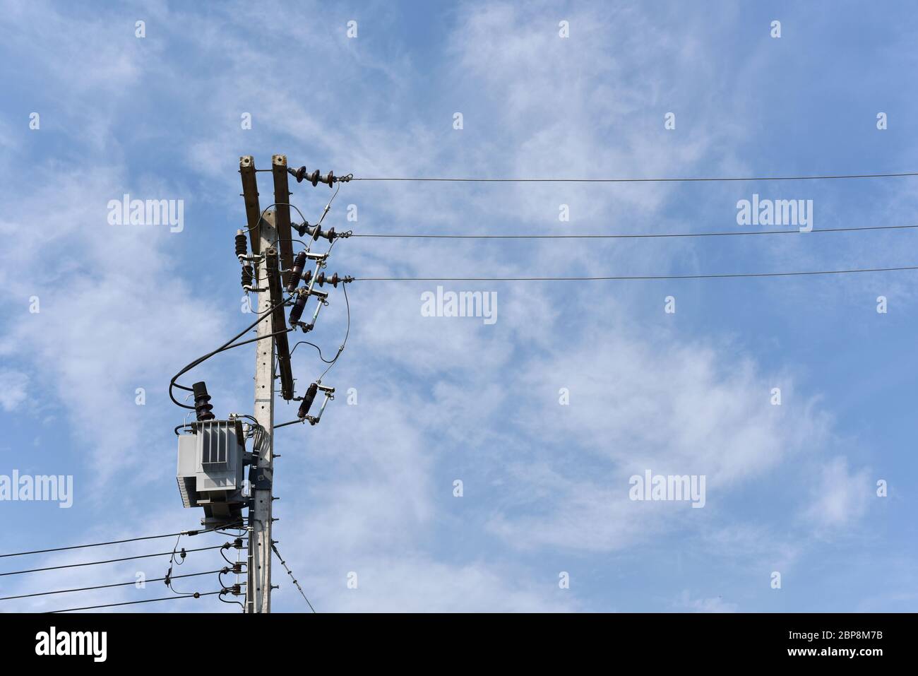 Energy and technology: electrical post by the road with power line ...