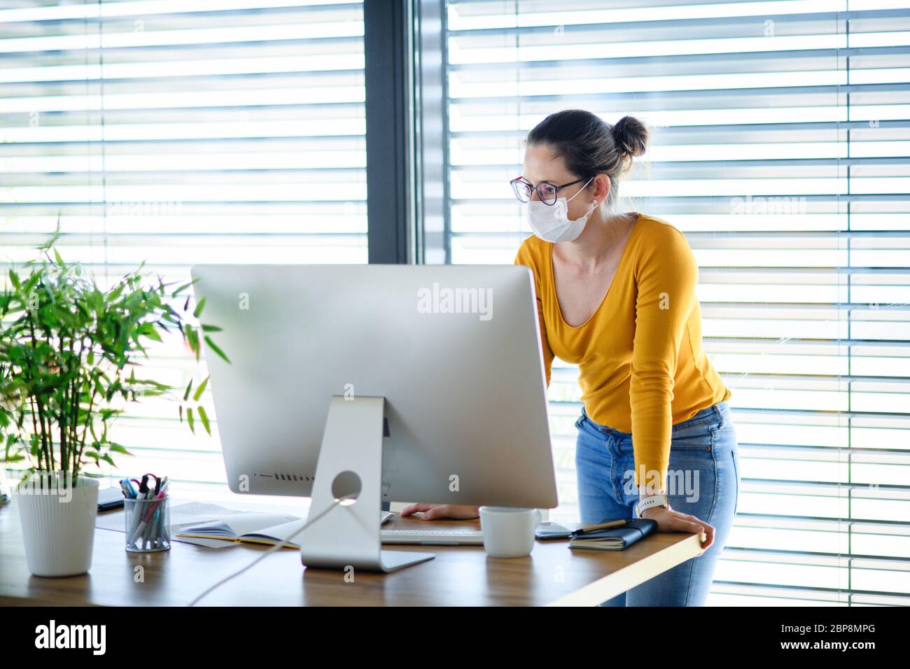 Woman working indoors at home office, Corona virus and quarantine ...