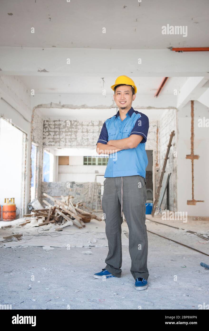 Asian construction worker with hardhat standing at site Stock Photo - Alamy