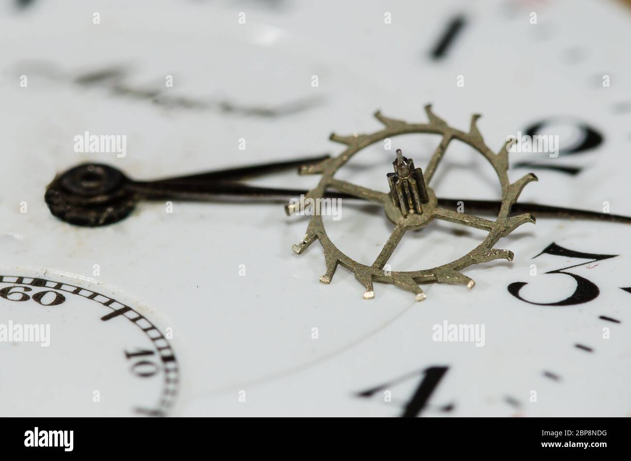 Watch Parts: Vintage Metallic Escape Wheel Resting on Pocket Watch Face ...