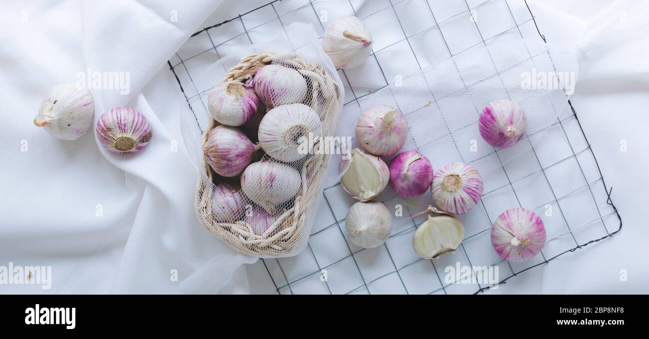 a group of many garlic cloves on white background Stock Photo - Alamy