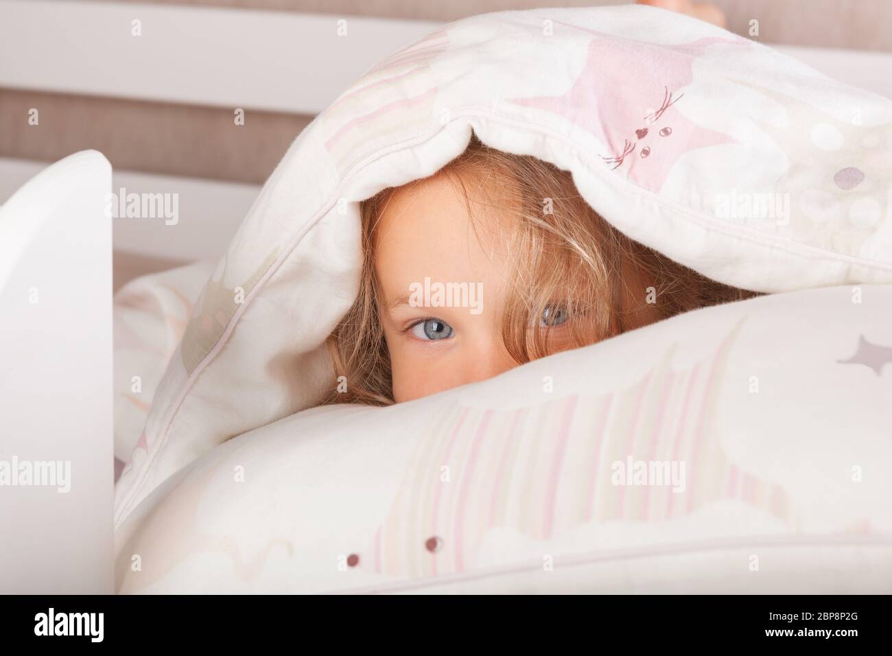 Cute kid Hiding Under The Blanket Stock Photo - Alamy