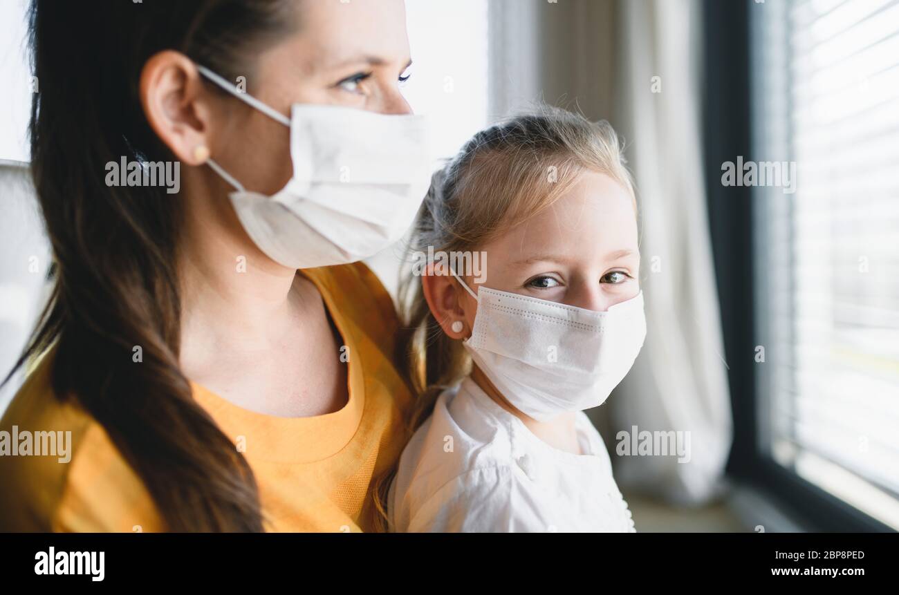 Mother and child with face mask indoors at home, Corona virus and ...