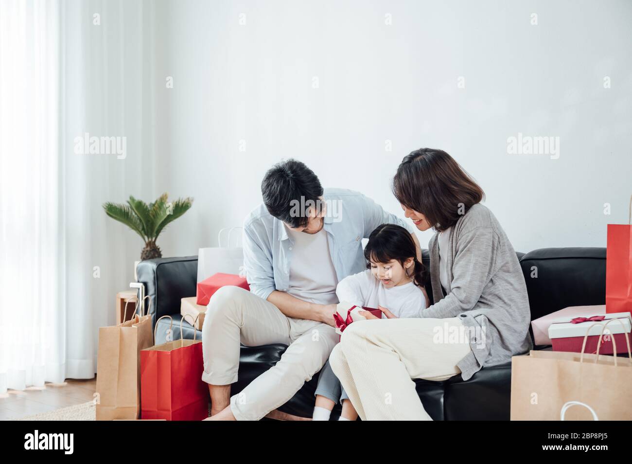 Child opening gifts hi-res stock photography and images - Alamy