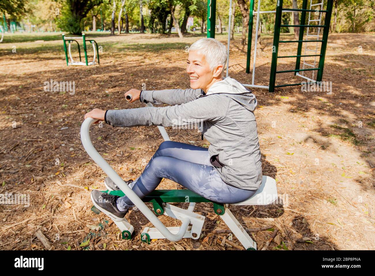 Healthy Mature Woman Practicing At Outdoor Gym, Sports Clothes, Sporty ...