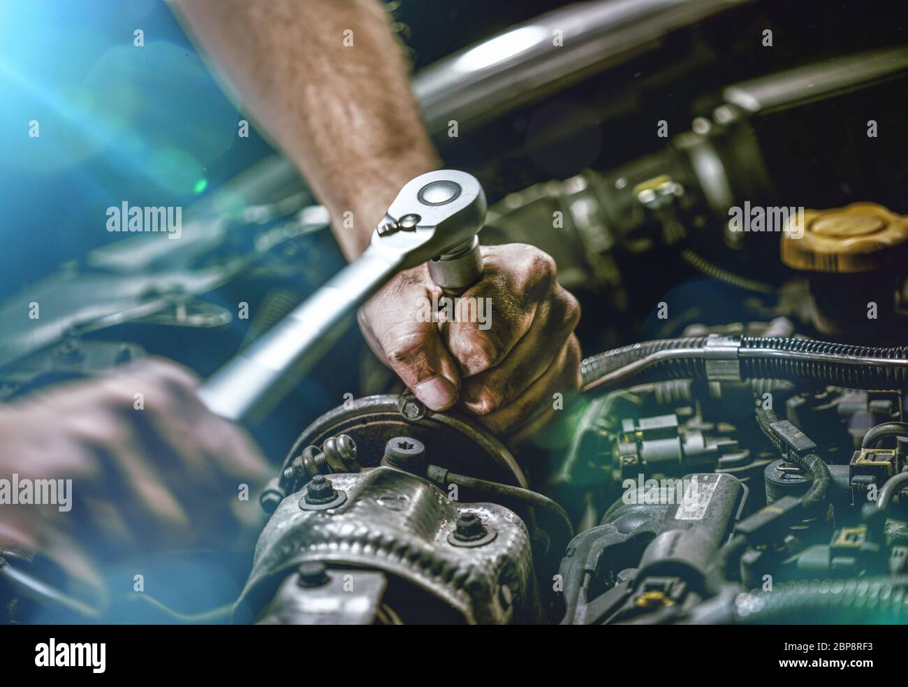 Auto mechanic working on car engine in mechanics garage. Repair service ...