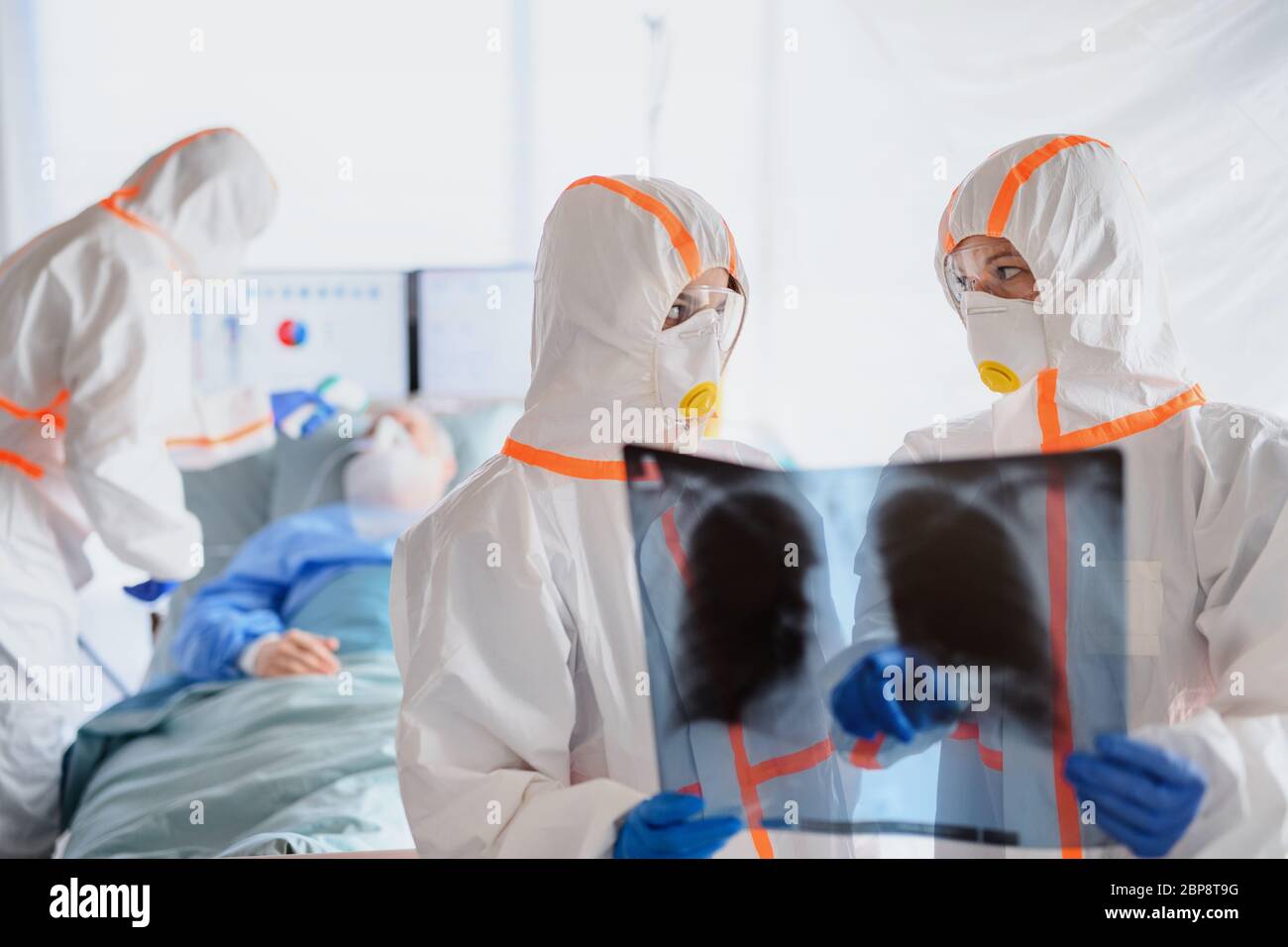 Medical team looking after infected patient in hospital, coronavirus ...