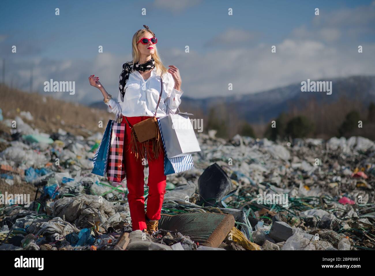 Modern woman on landfill, consumerism versus pollution concept Stock ...
