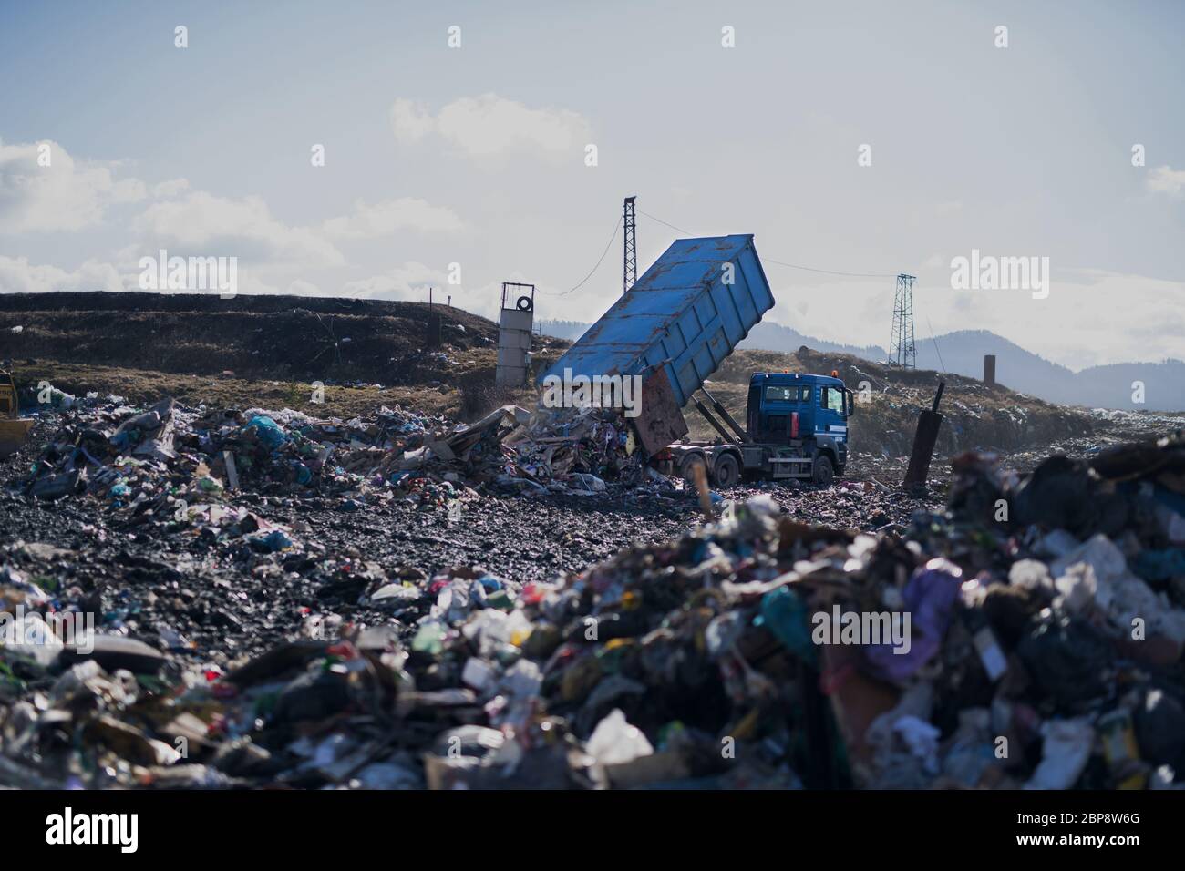 Garbage truck unloading waste on landfill, environmental concept Stock ...