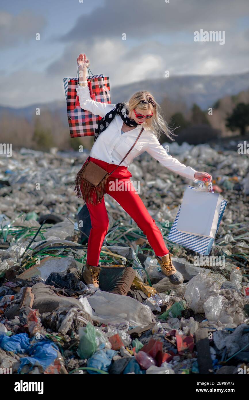 Modern woman on landfill, consumerism versus pollution concept Stock ...