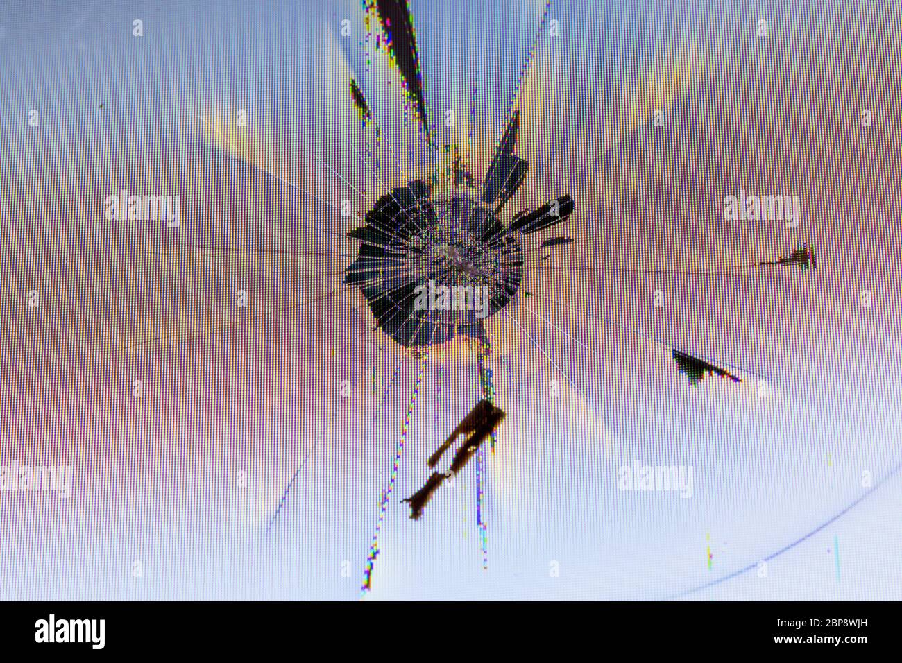 close-up view of physically damaged lcd screen surface with impact spot ...