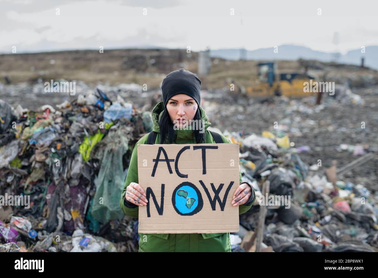 Woman activist with placard poster on landfill, environmental pollution ...