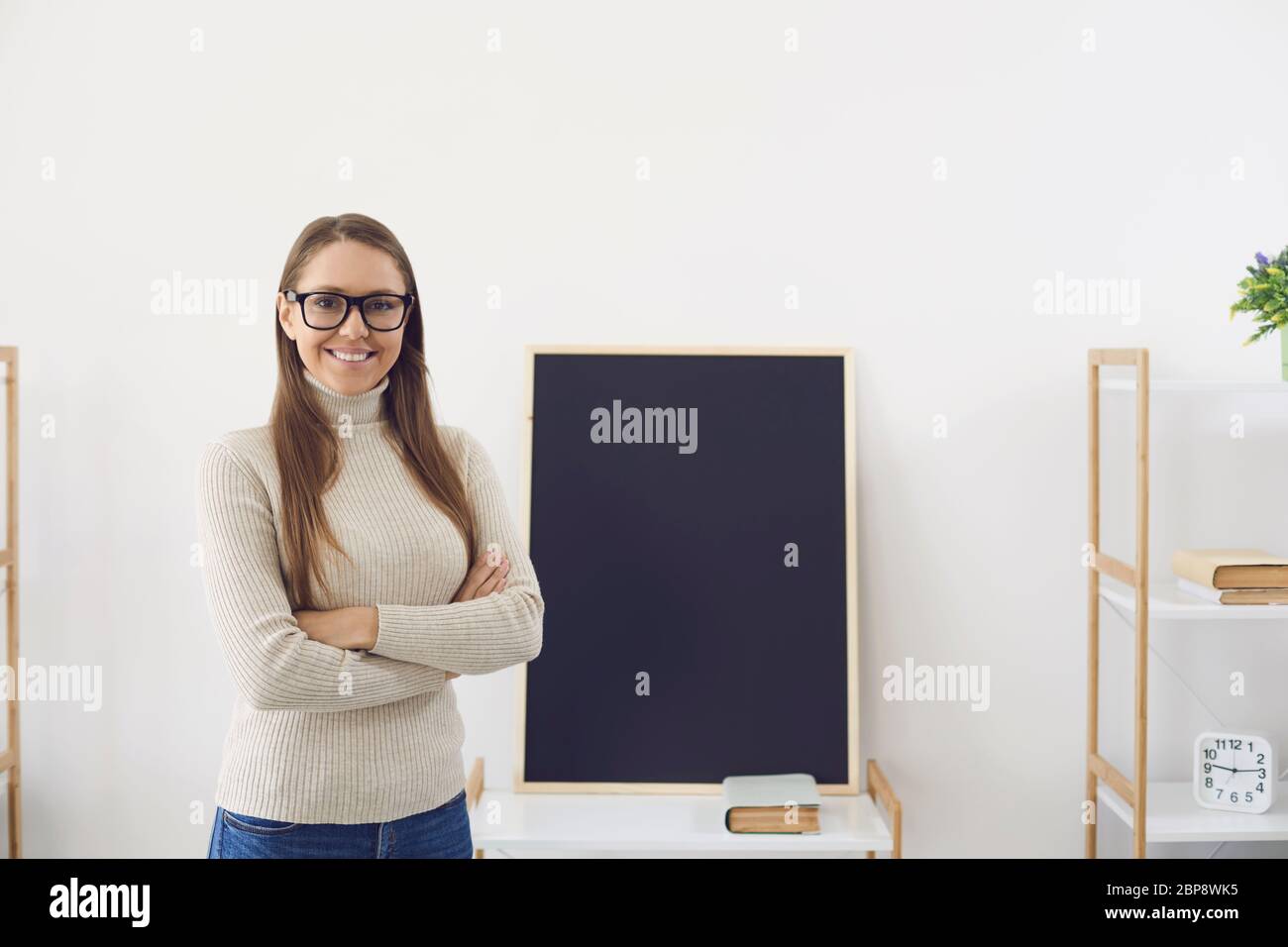 Online learning. A teacher with glasses smiling smiles into the camera ...