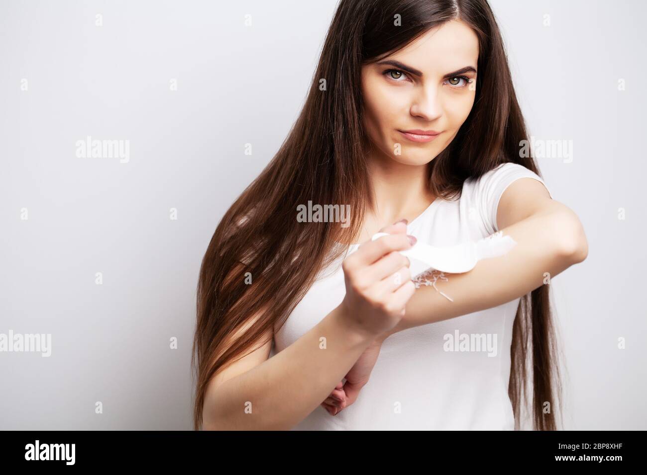 Young woman doing hair removal at home in the hands area Stock Photo ...