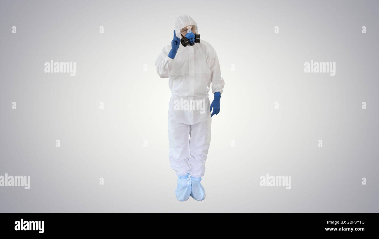 Doctor wearing hazard suit pointing with finger up wanting your ...