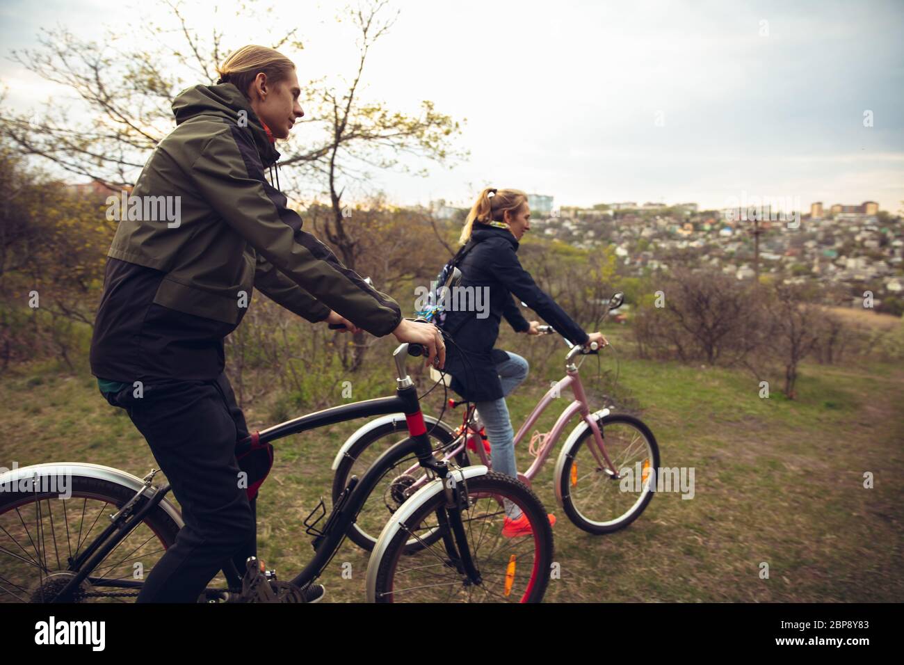 Best friends having fun near countryside park, riding bikes, spending ...