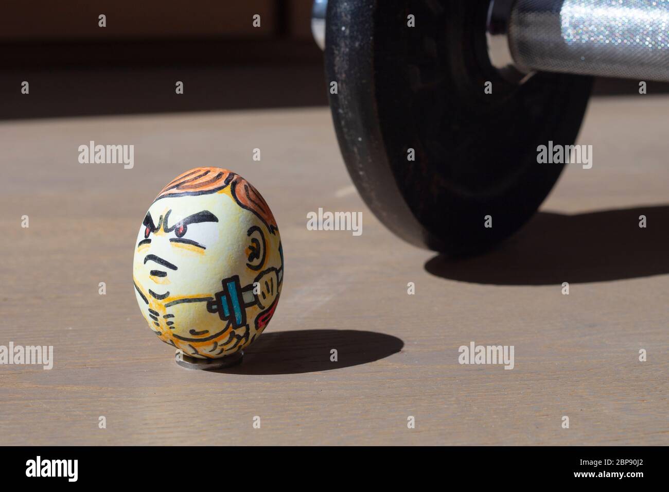 Colorful strong muscular bodybuilder Easter egg in wooden background ...