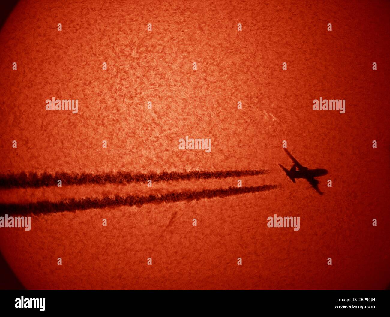 High flying aircraft passing in front of the sun, imaged captured with ...
