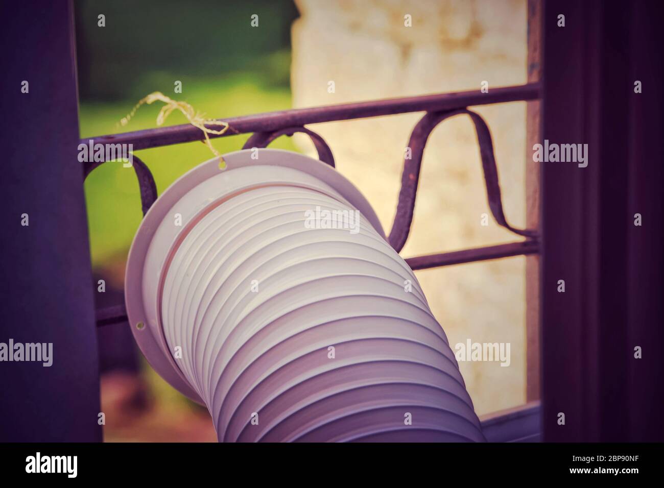 Exhaust air hose hanging out of the window Stock Photo - Alamy