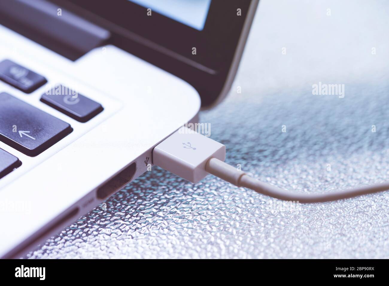 usb cable into laptop, close up photo Stock Photo - Alamy