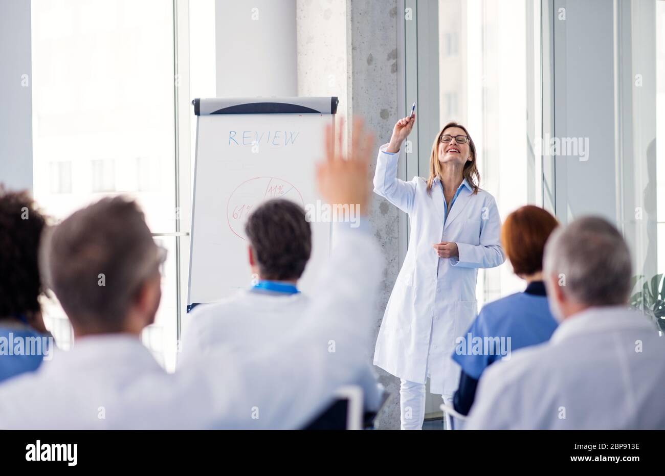 Group of doctors on conference, medical team sitting and listening to ...