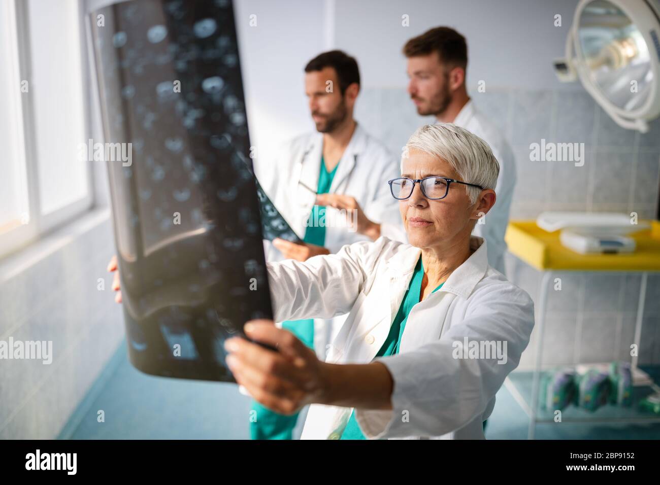 Medical team doctors checking on X-ray results in hospital Stock Photo ...