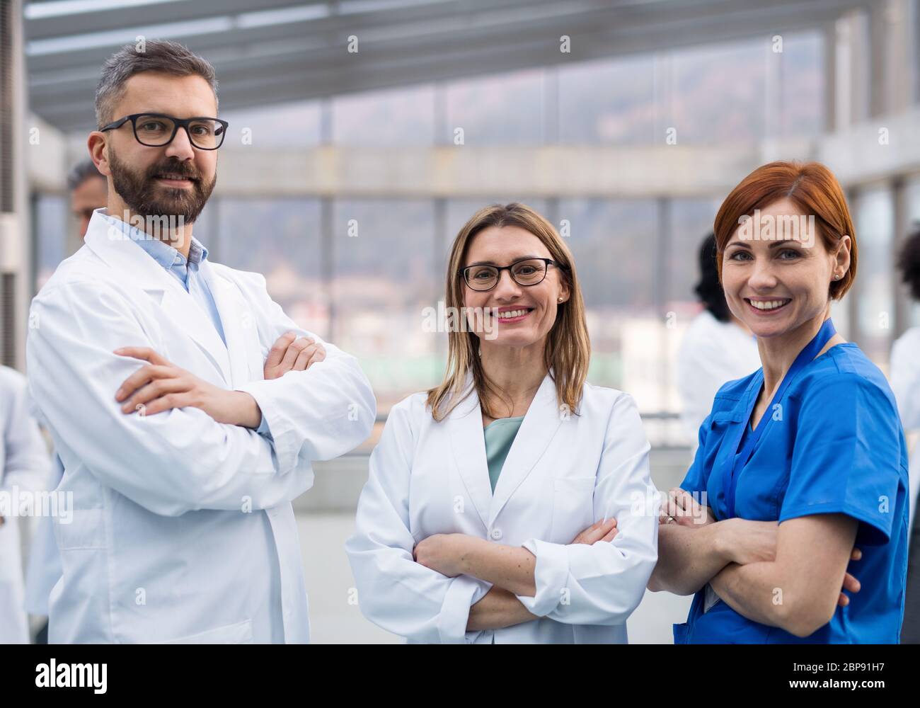 Group of doctors standing in corridor on medical conference Stock Photo ...