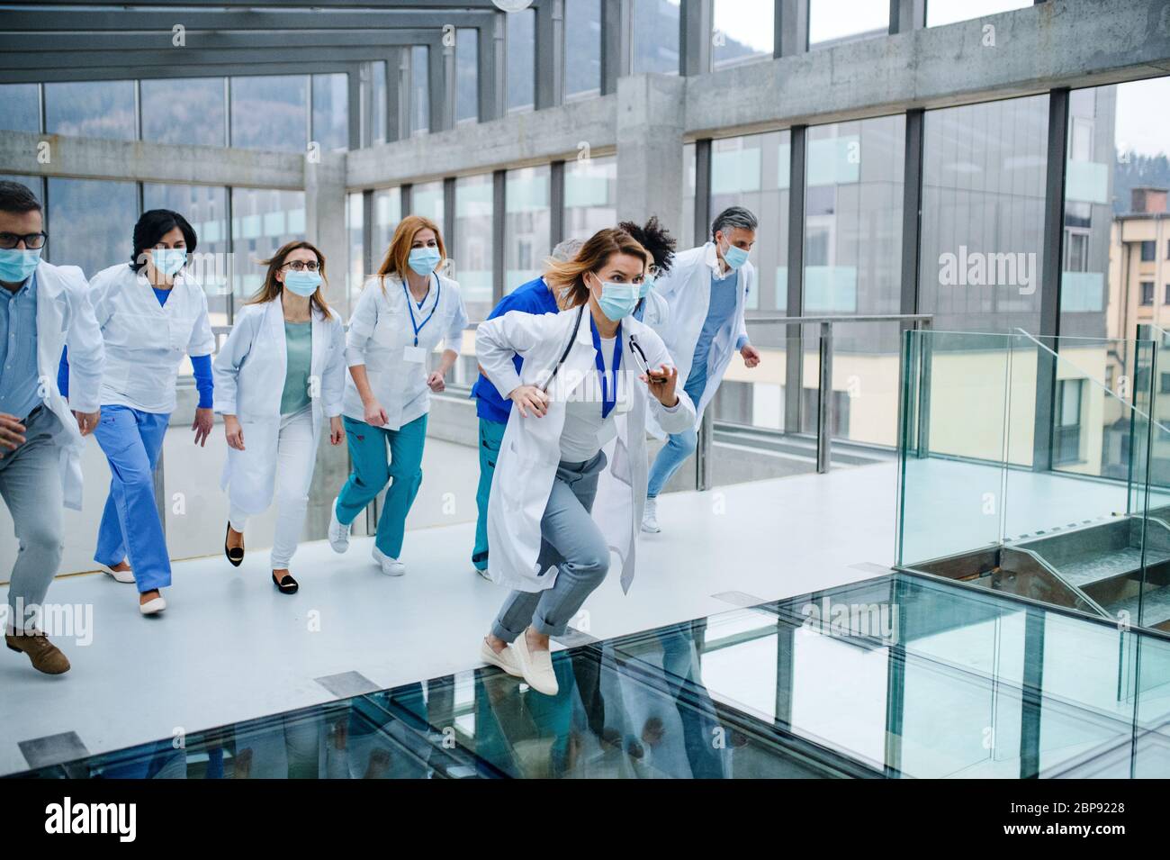 Group of doctors running in corridor of hospital, emergency concept ...