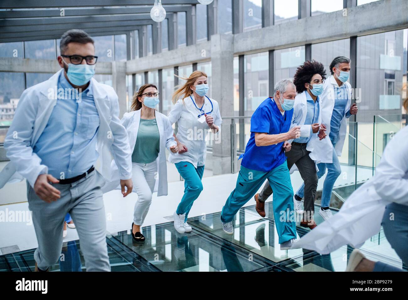 Group of doctors running in corridor of hospital, emergency concept ...