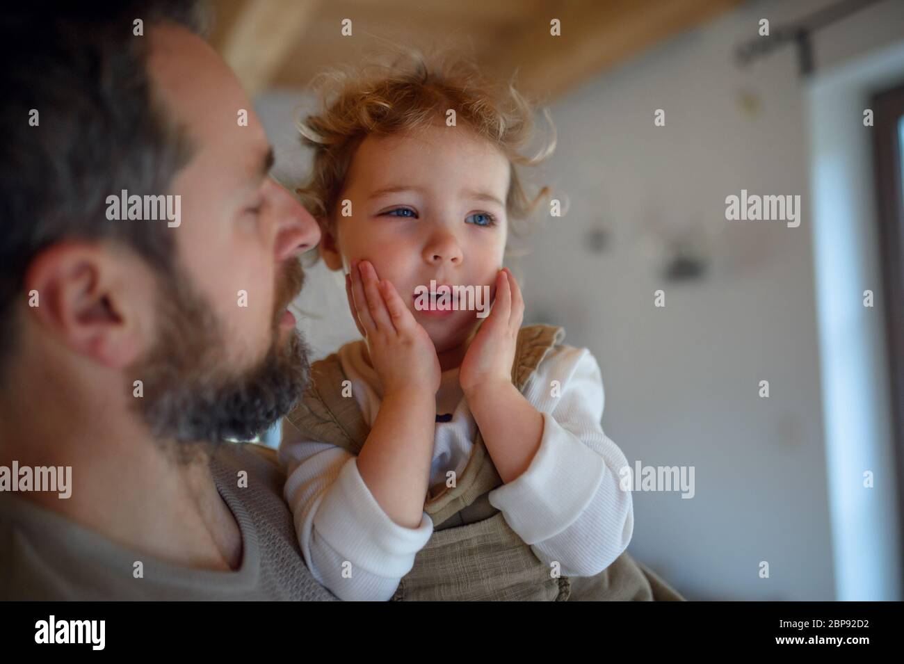Father with small sick crying toddler daughter indoors at home Stock ...
