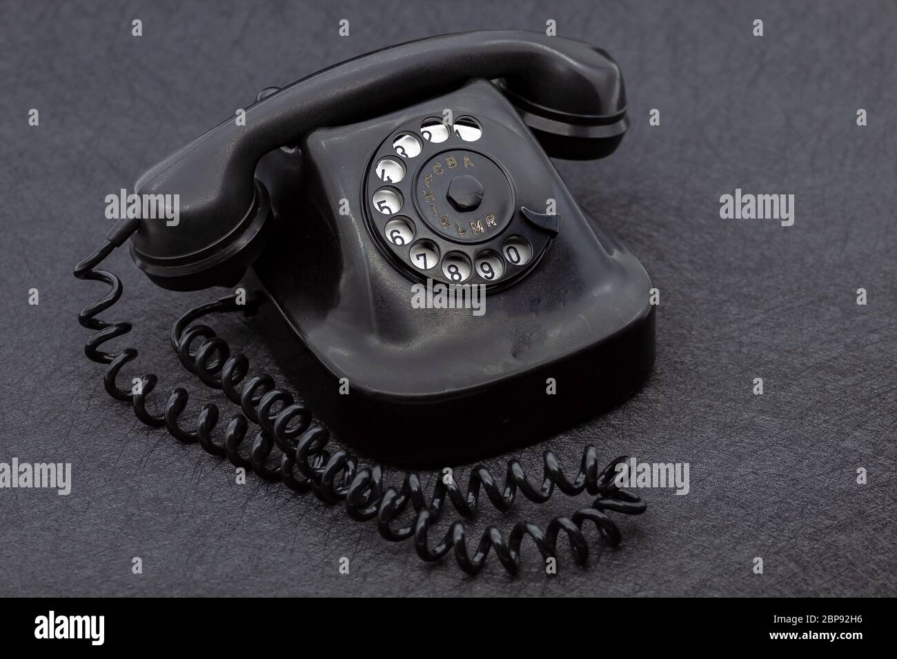Vintage analog bakelite phone in black color. Selective focus with ...