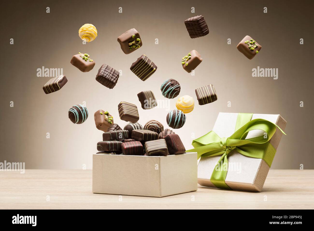 mix of chocolates jumping from gift box Stock Photo - Alamy
