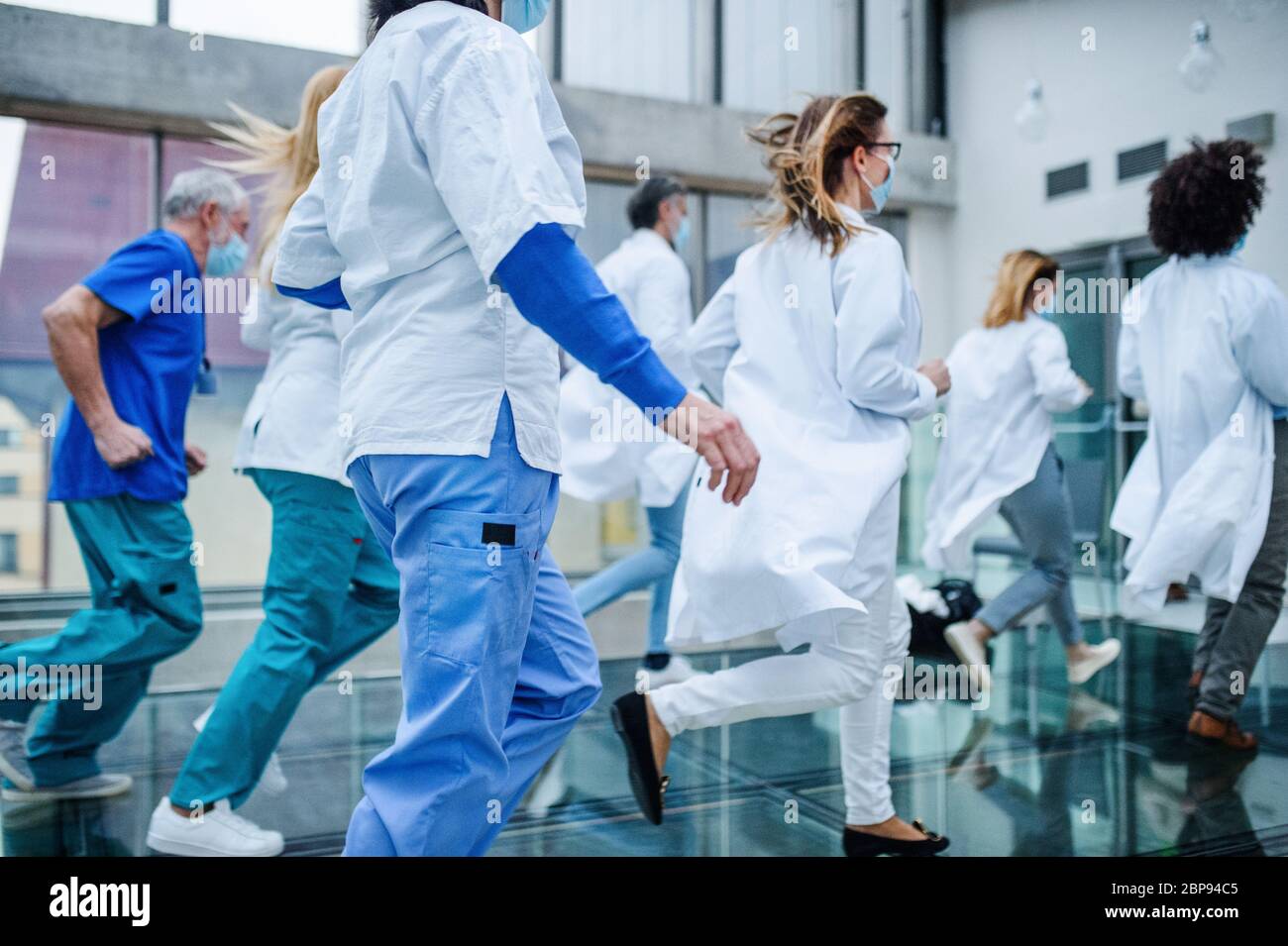 Group of doctors running in corridor of hospital, emergency concept ...