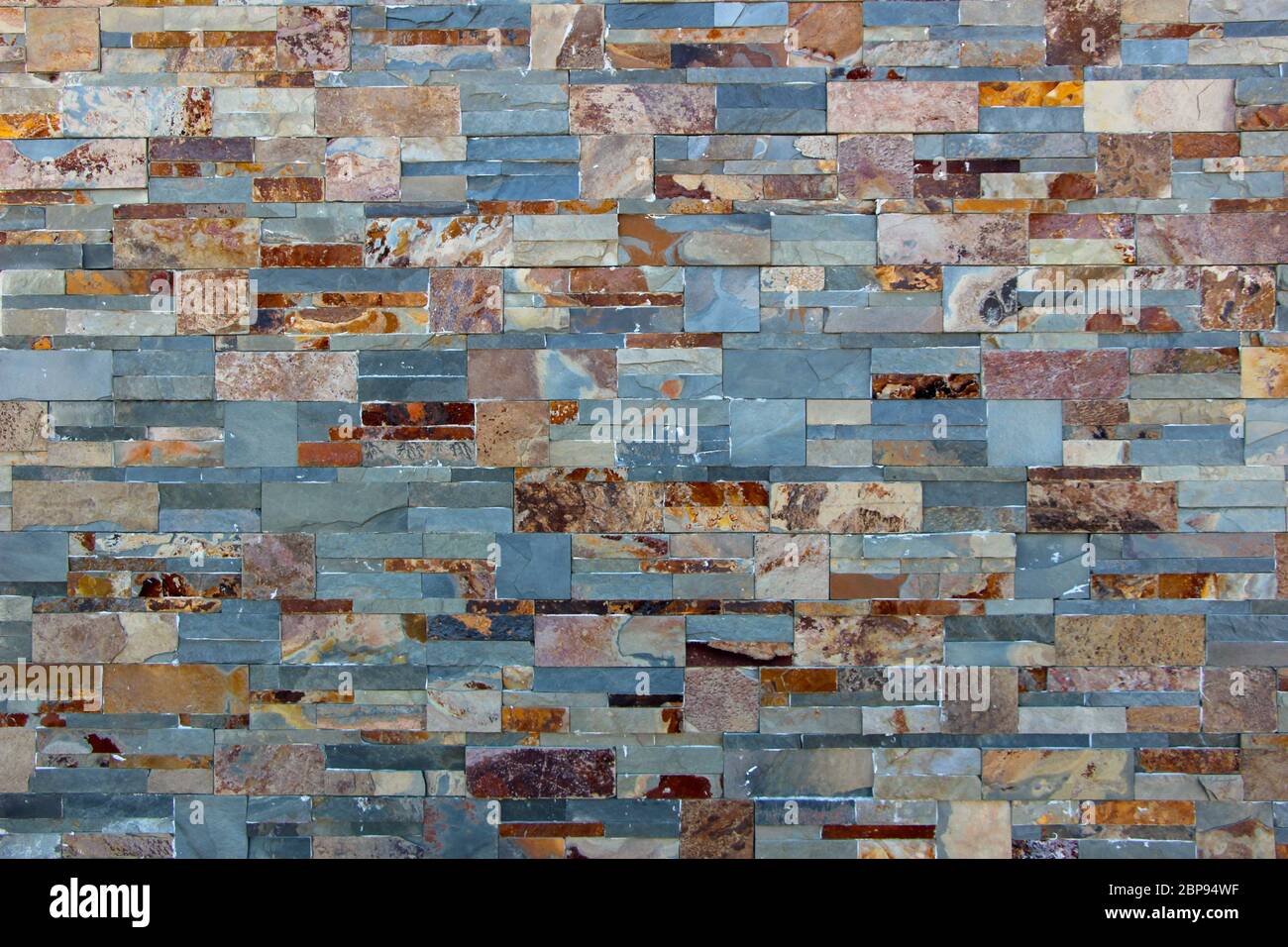 Multi coloured wall with small tiles or bricks Stock Photo - Alamy