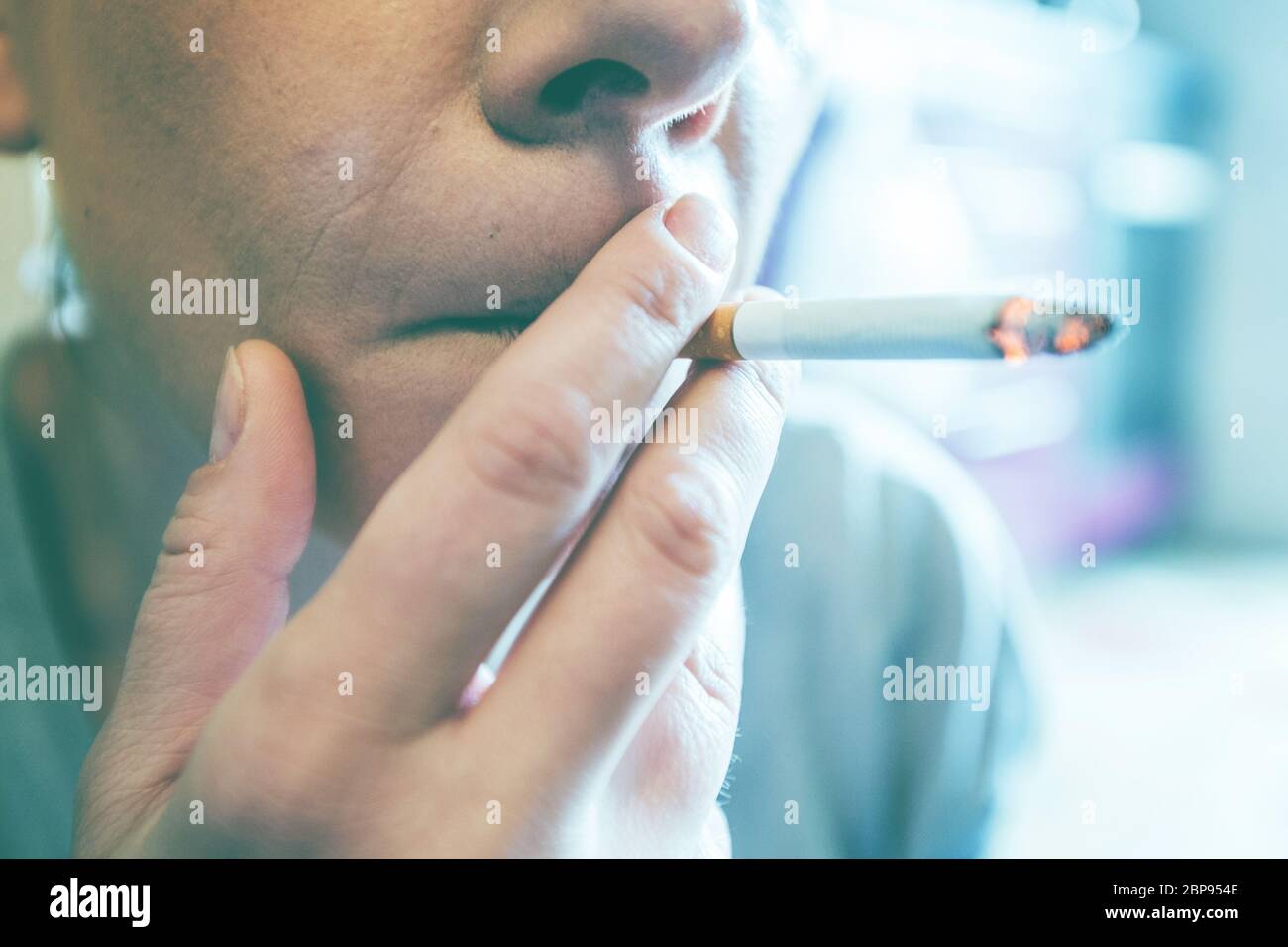 Closeup of depressed woman smoking cigarette Stock Photo - Alamy