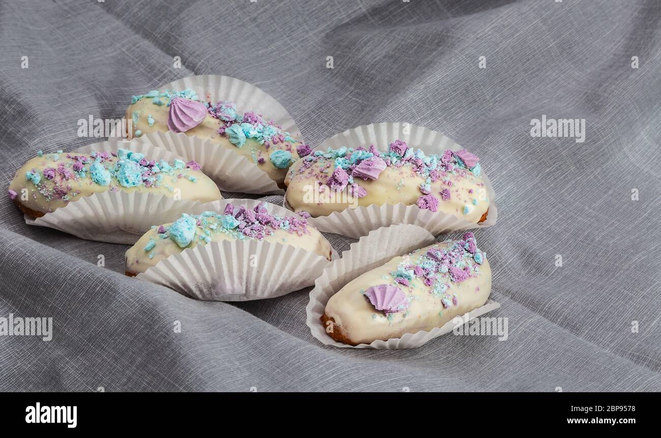 Traditional french eclairs is typically piped into an oblong shape with ...