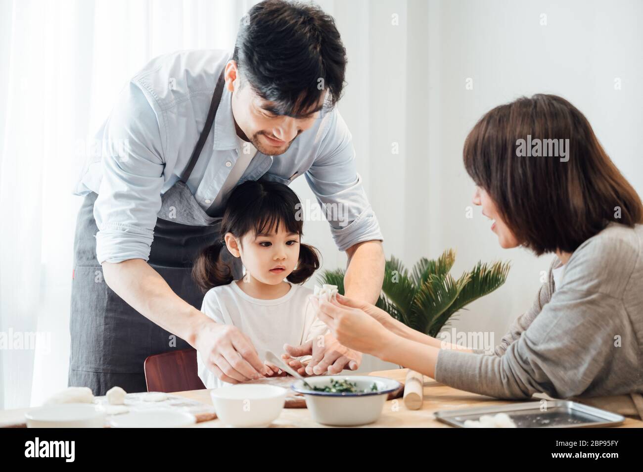 Mom and Dad and daughter at home dumplings Stock Photo - Alamy