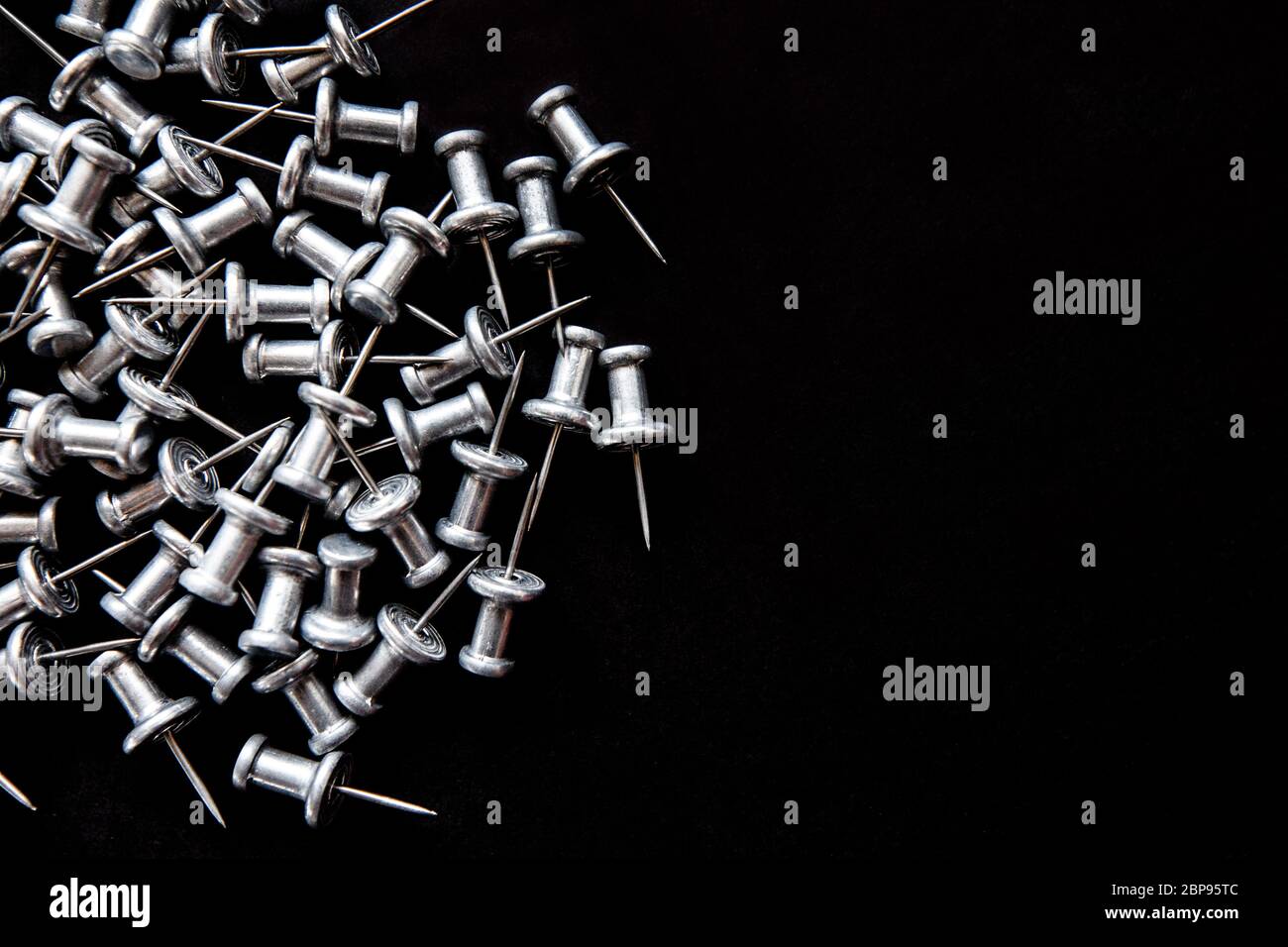 grey pins on a black background close up, copy space Stock Photo - Alamy