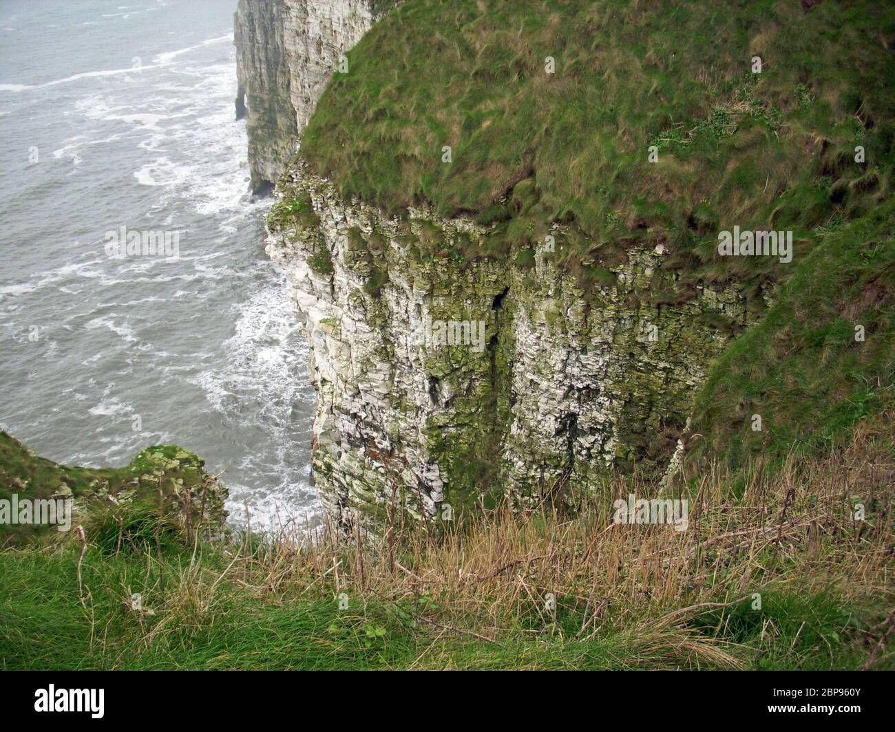 High chalk cliffs with sea and mist. Grey sky as background Stock Photo ...