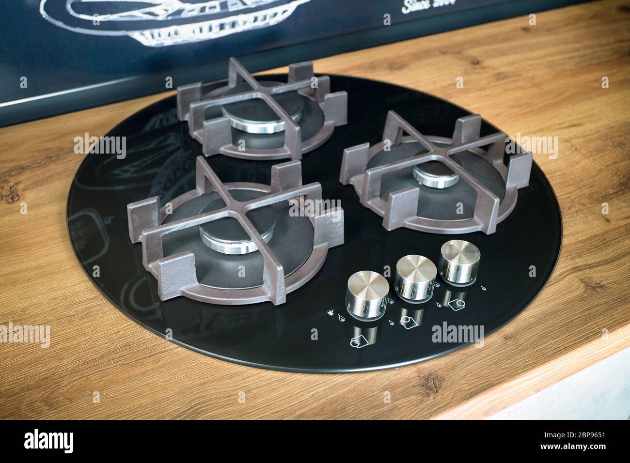 Modern kitchen equipment concept, black tempered glass round shape gas ...