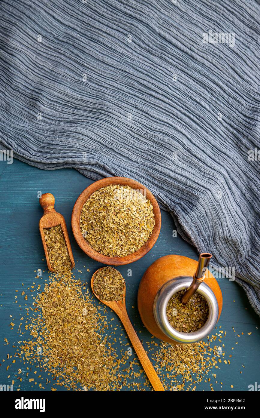 Yerba mate in a traditional calabash gourd, dry mate in bowl, space for ...