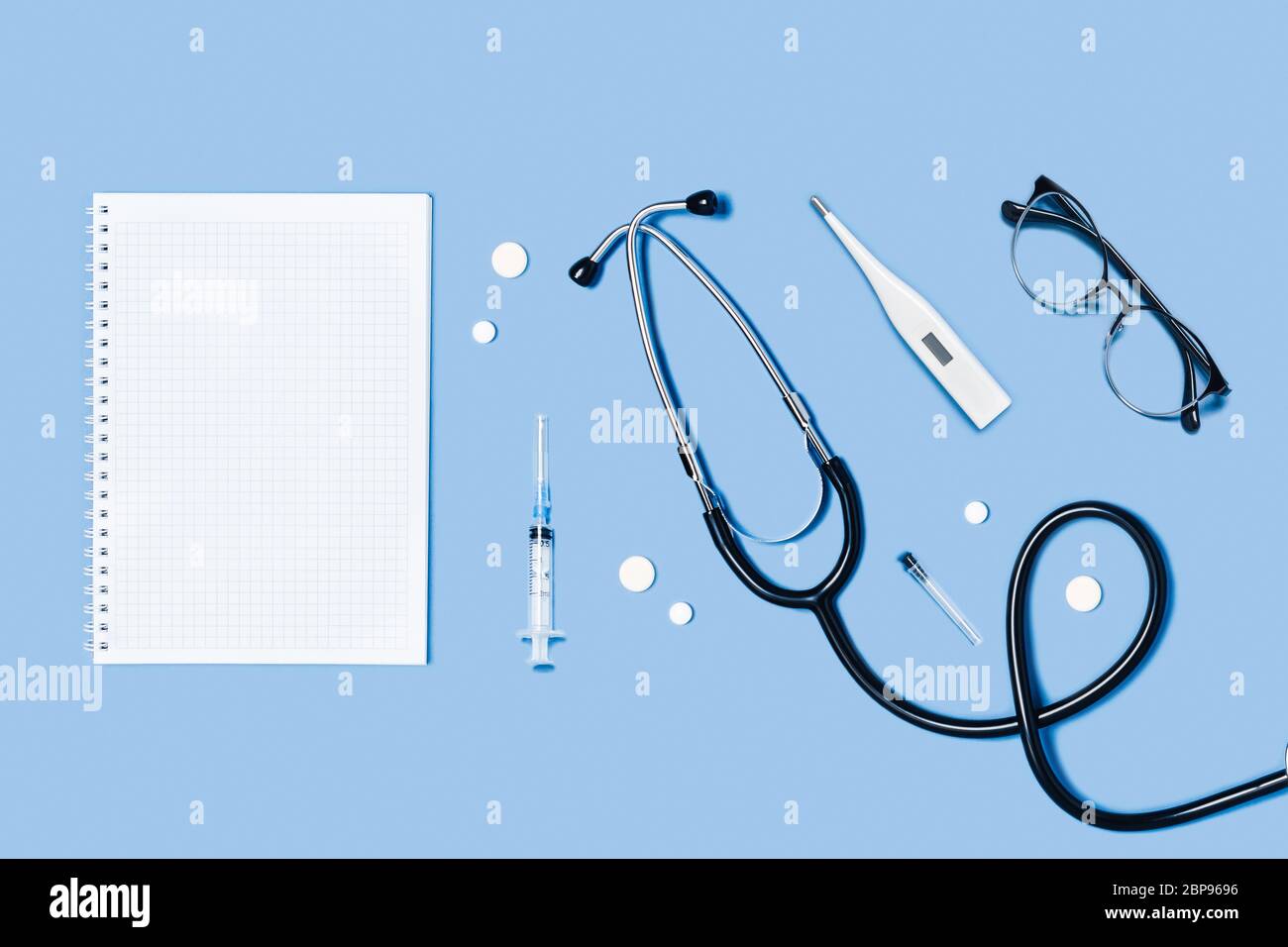 Medical blue background with different accessories: stethoscope ...